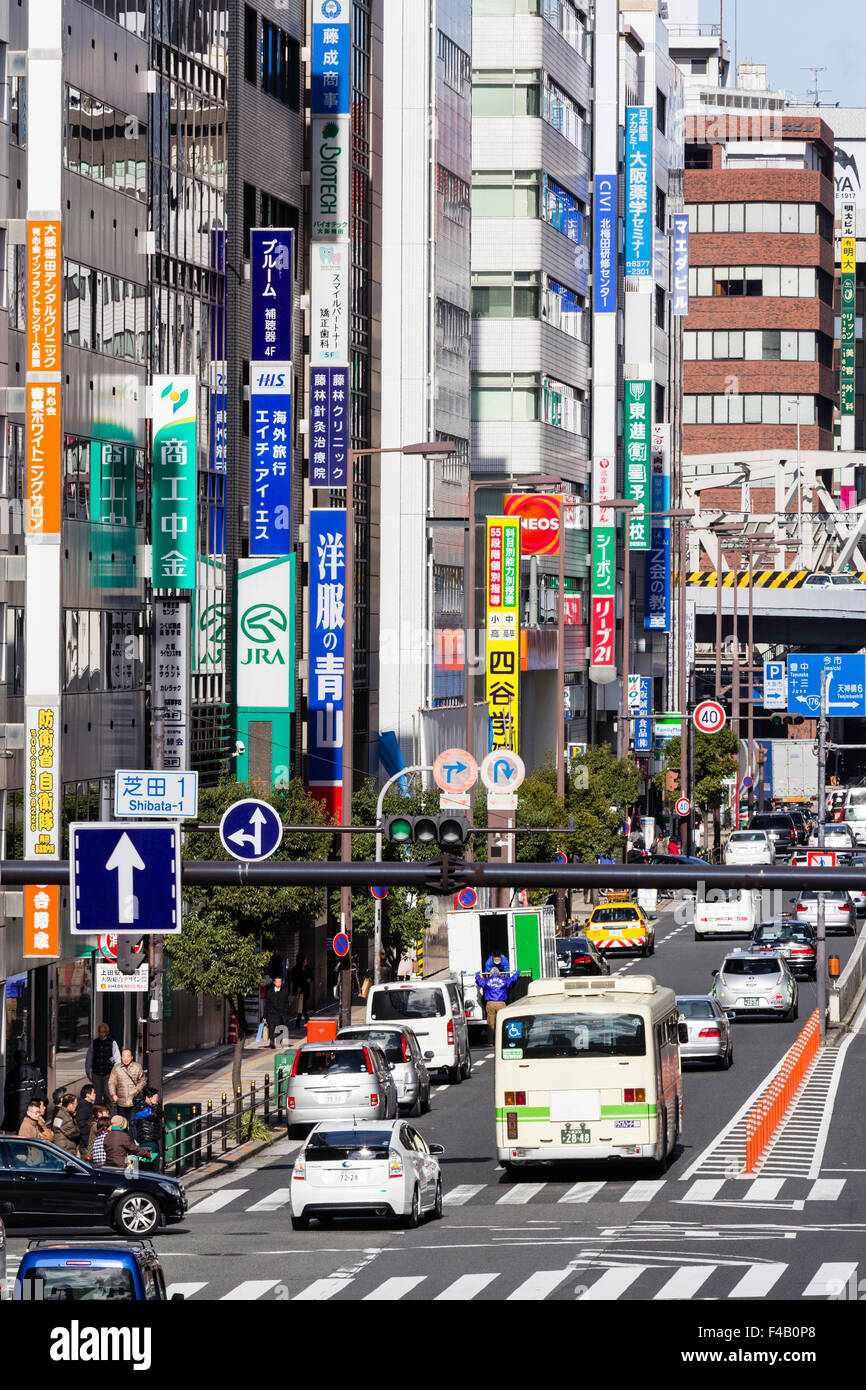 Japan, Osaka, Umeda, view along main street showing masses of shop ...