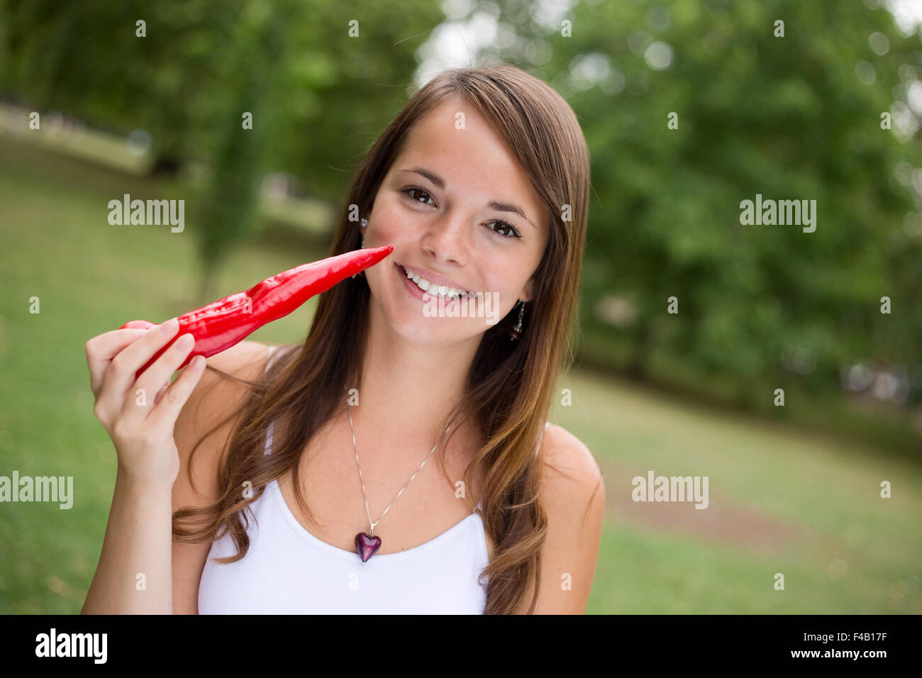young woman holding a red chilli Stock Photo - Alamy