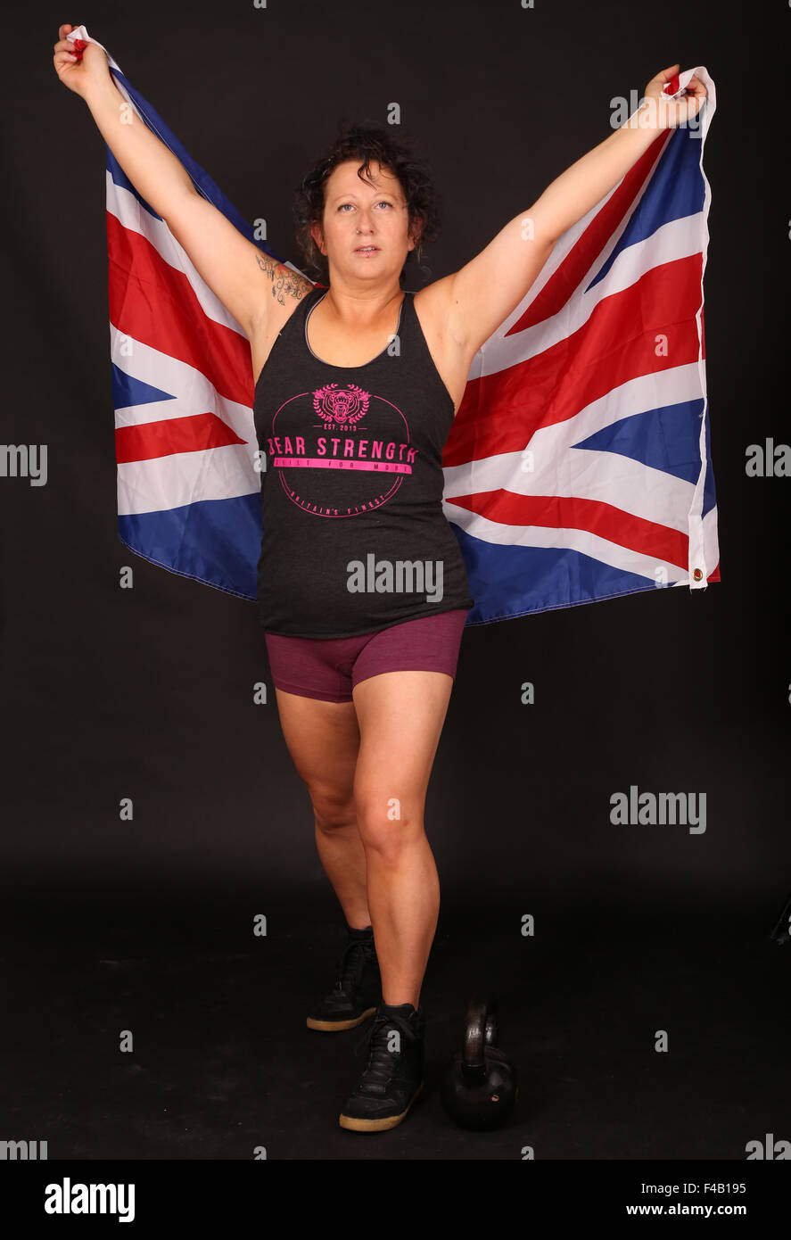 Female boxer in the studio, with British union flag celebrating a ...