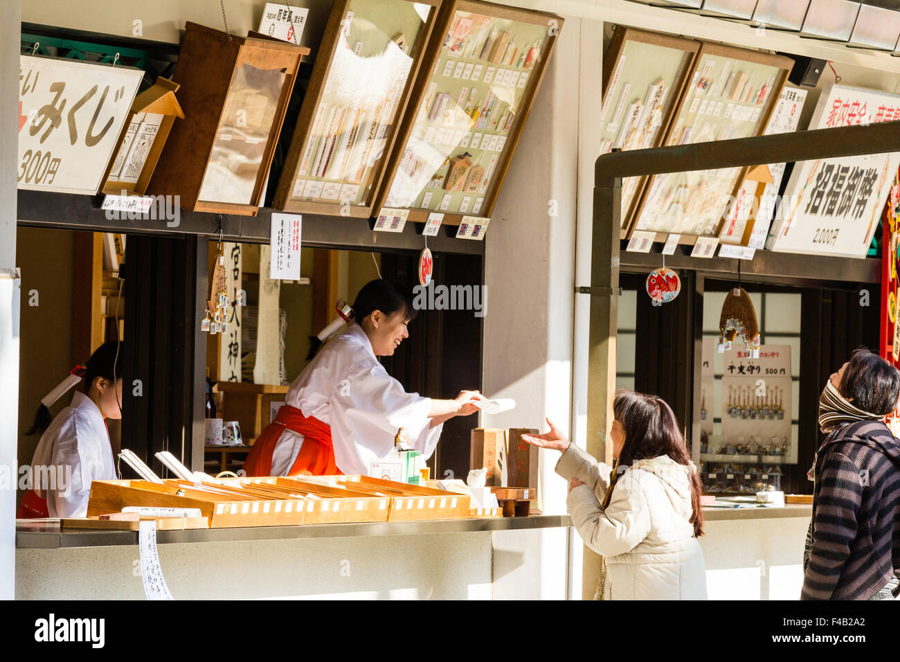Japan, Nishinomiya Shinto shrine, counter with miko, shrine maiden ...