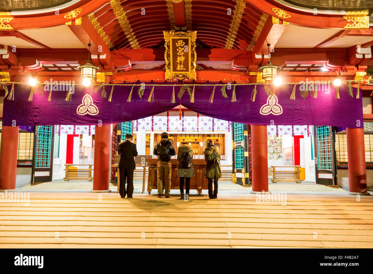 New Year eve, Japanese Shinto Nishinomiya shrine. Four people standing ...