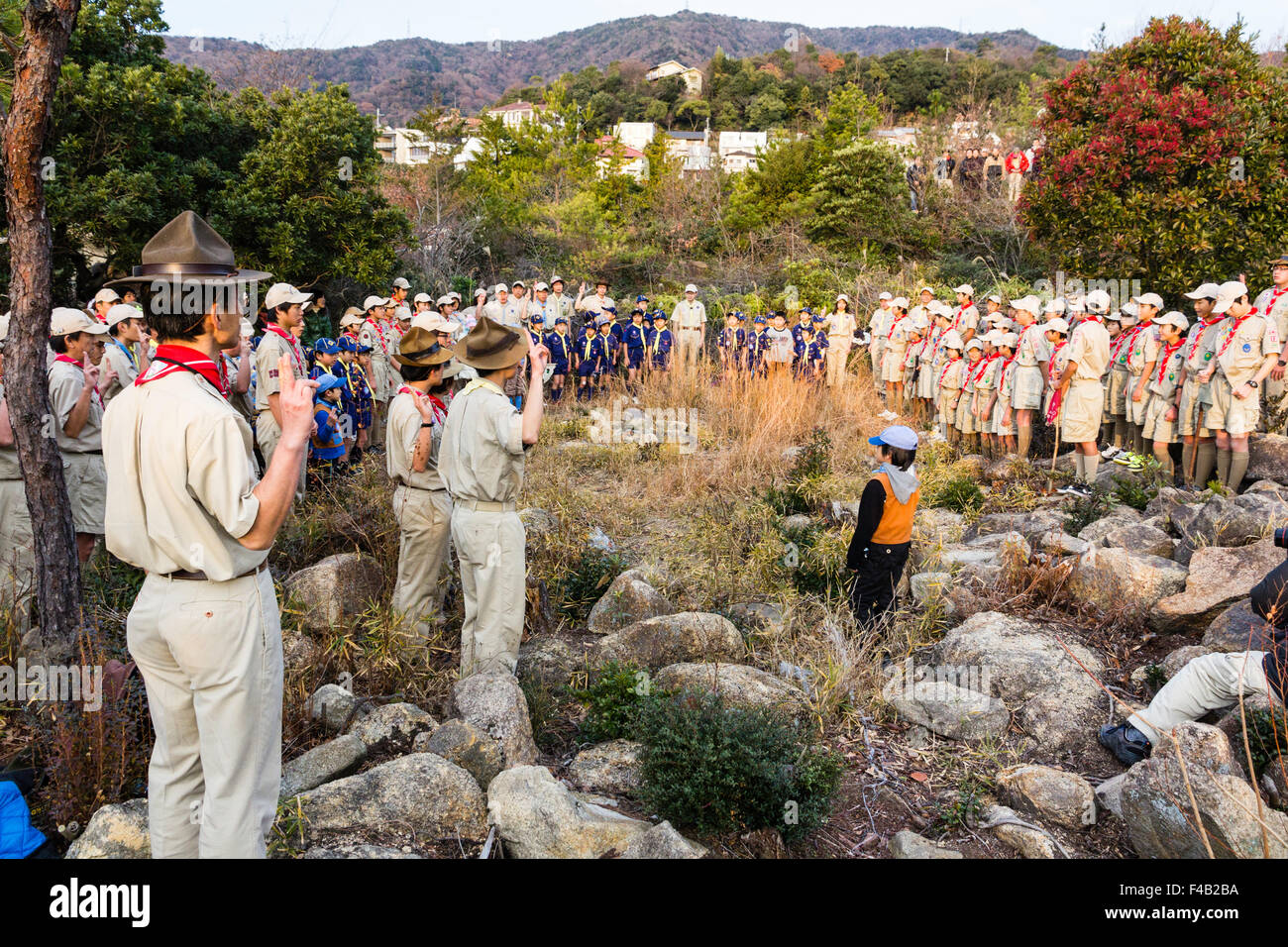 Japan. Boy scouts standing on mountain, saluting and making pledges at ...