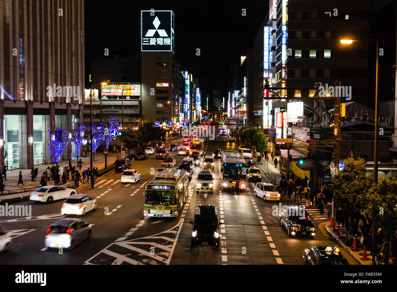 Osaka, Umeda at night. Traffic on six lane street outside the iconic ...