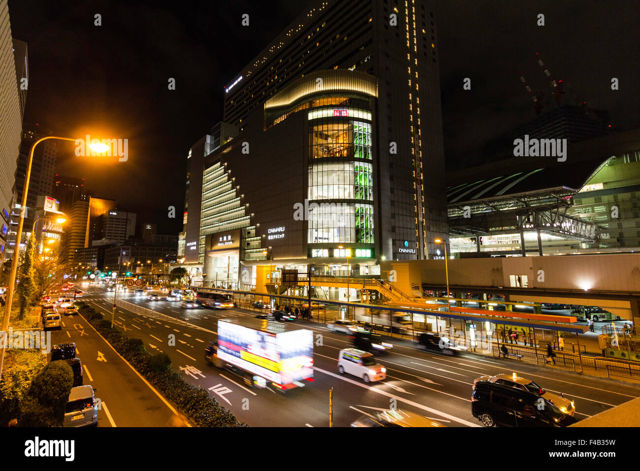 Osaka. Night time, the transport hub of Umeda, eight lane street with ...