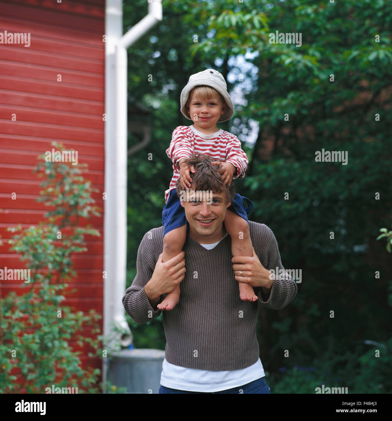 Boy sitting on man's shoulders outdoors Stock Photo - Alamy