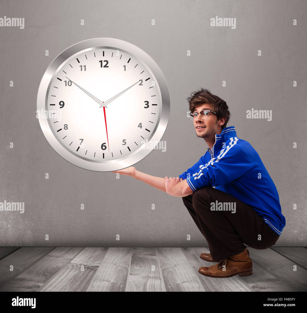Attractive boy holding a huge clock Stock Photo - Alamy
