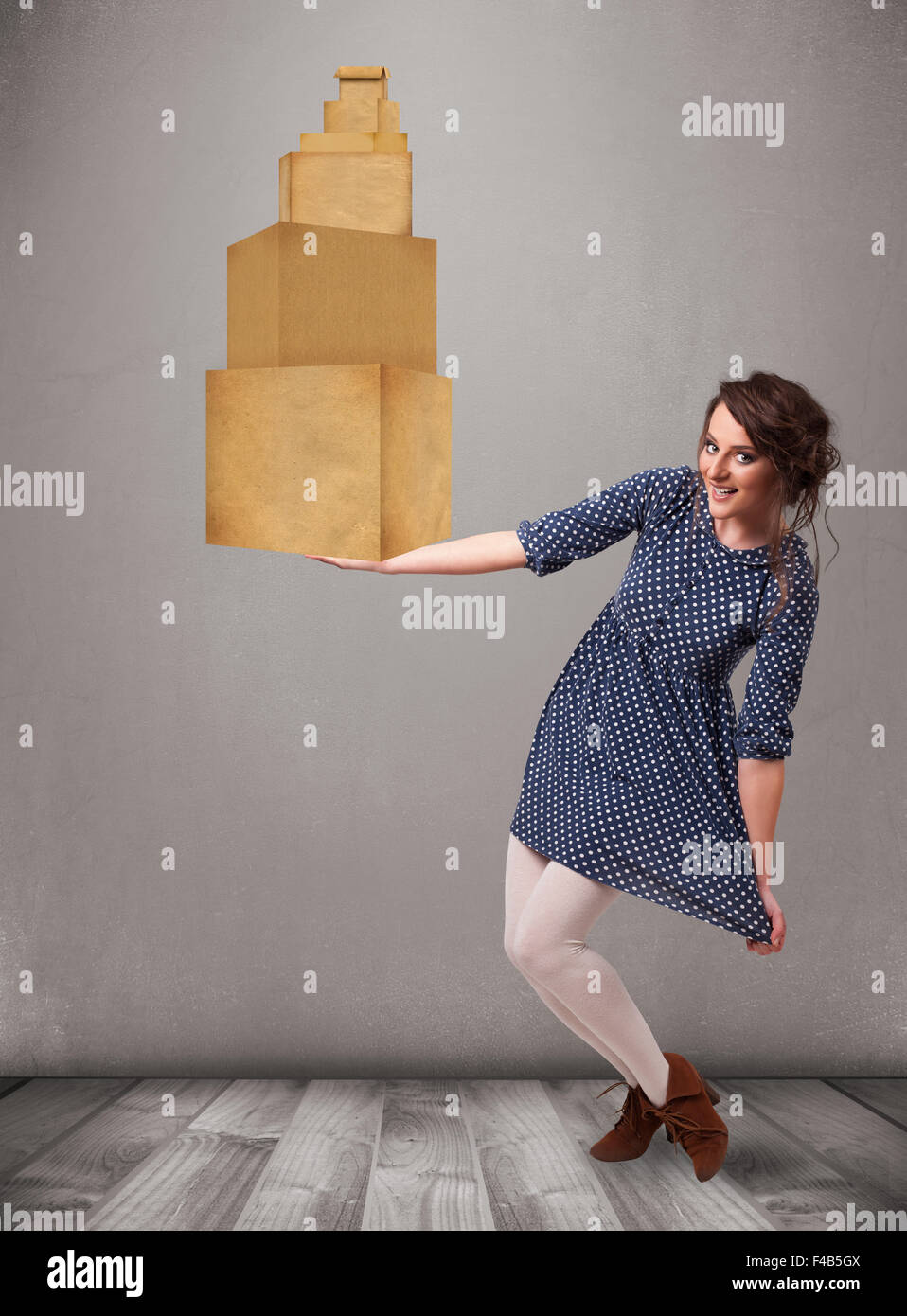 Young lady holding a set of brown cardboard boxes Stock Photo - Alamy