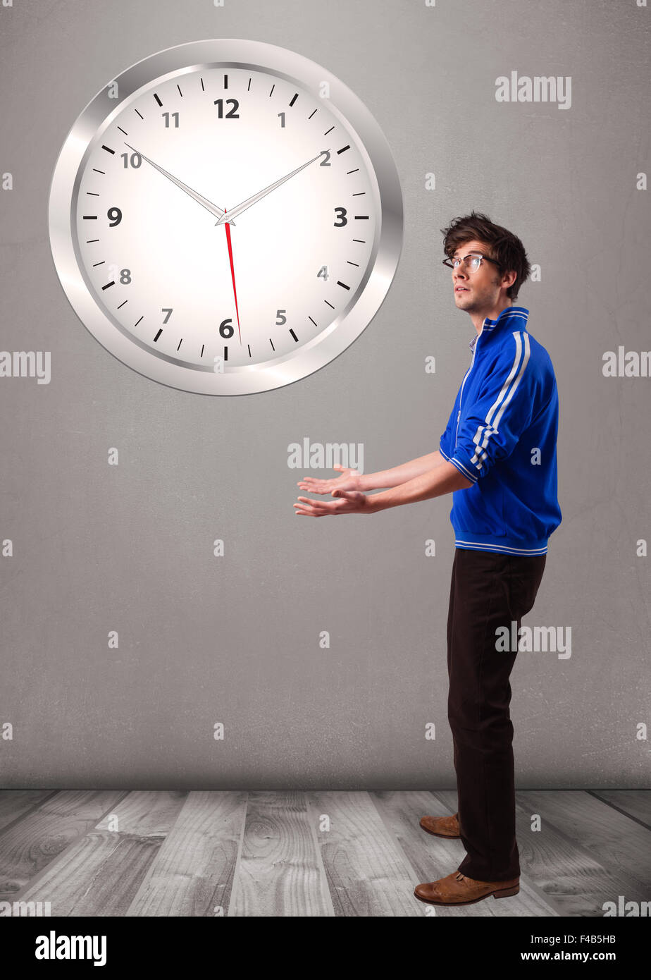 Attractive boy holding a huge clock Stock Photo - Alamy