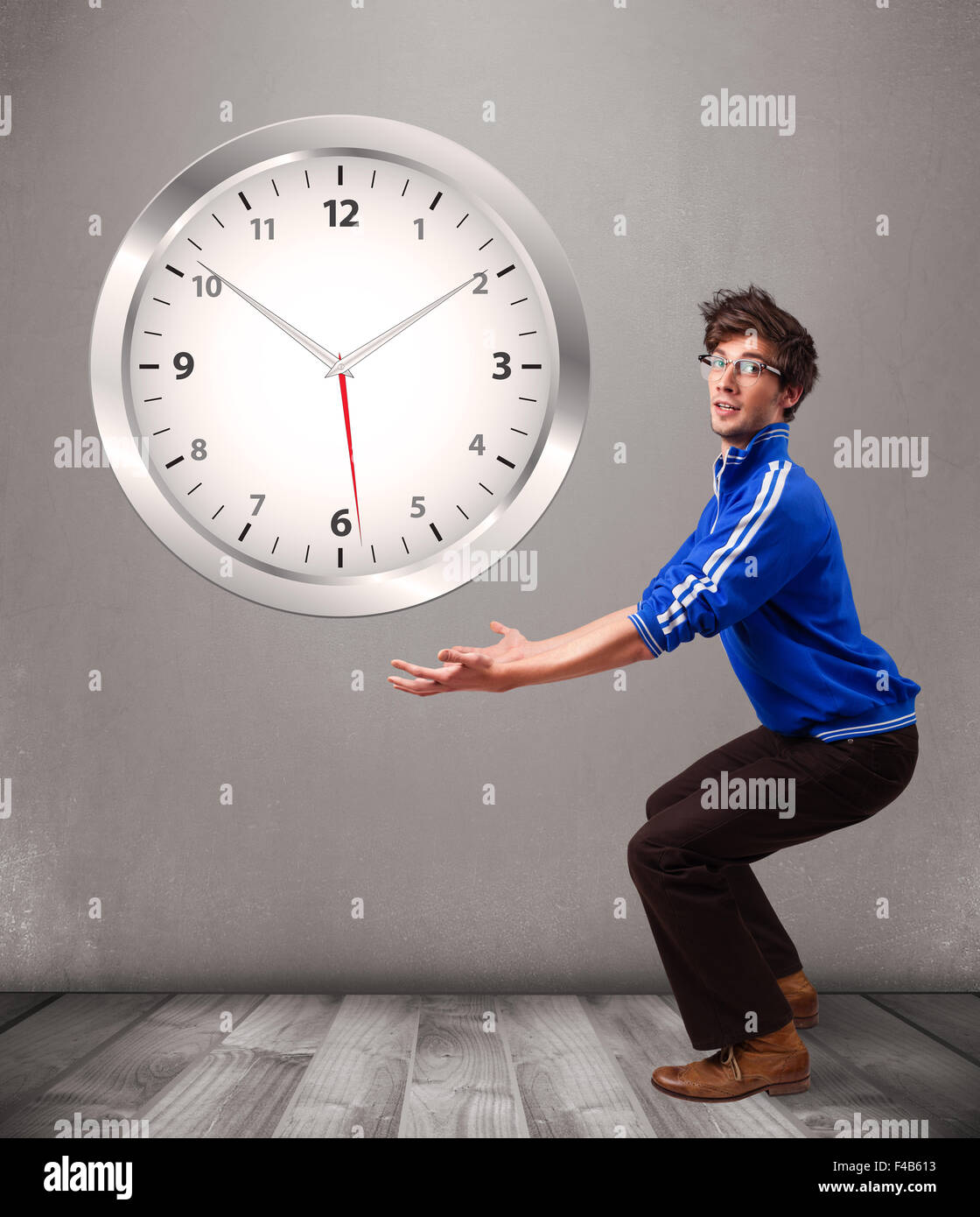 Attractive boy holding a huge clock Stock Photo - Alamy