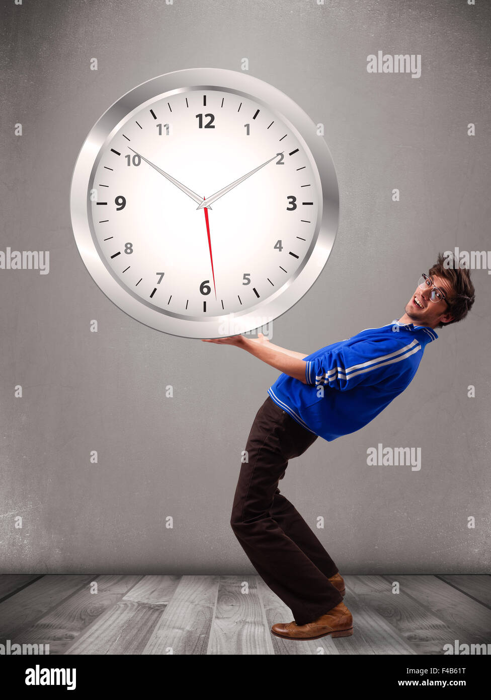 Attractive boy holding a huge clock Stock Photo - Alamy