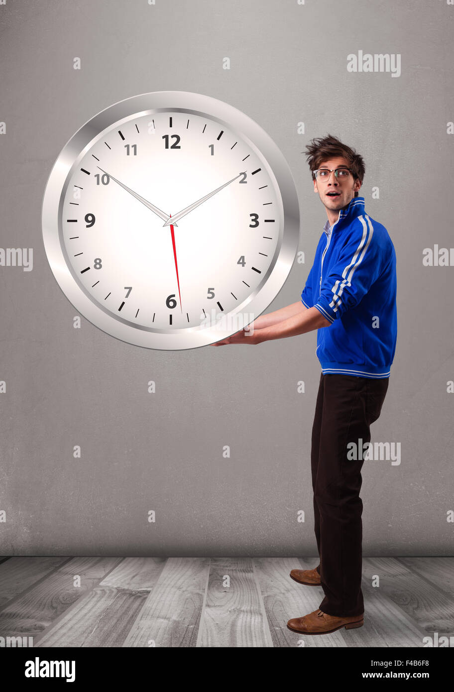 Attractive boy holding a huge clock Stock Photo - Alamy