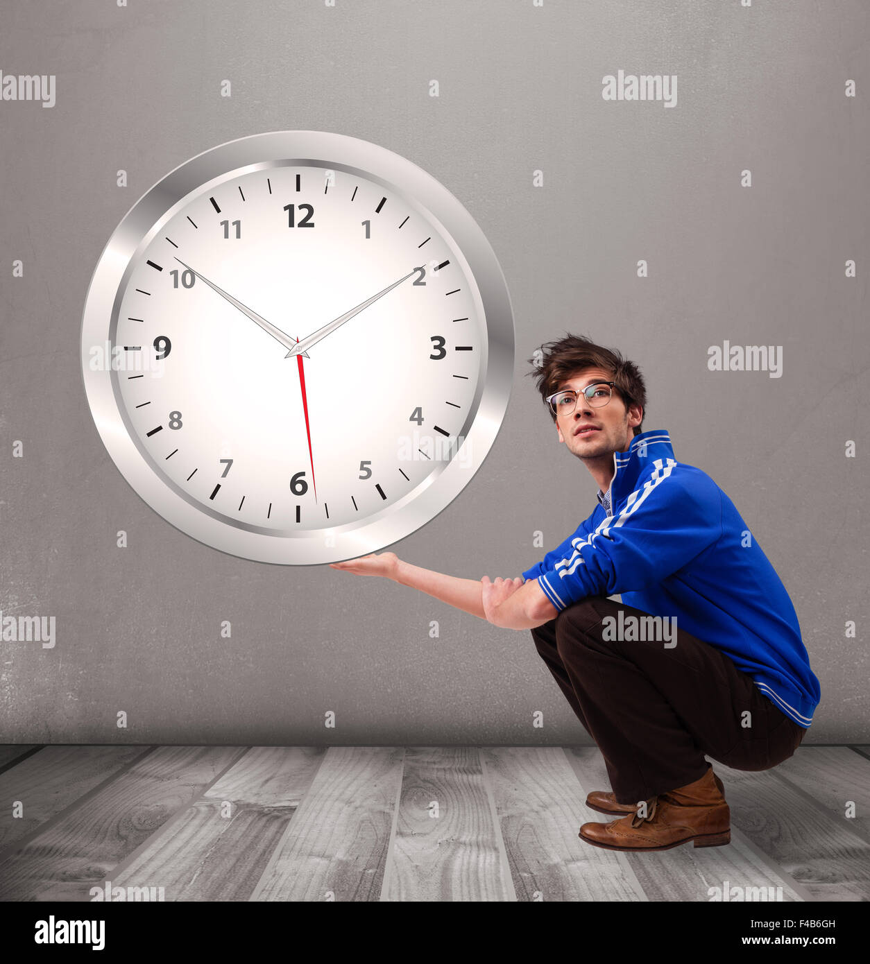 Attractive boy holding a huge clock Stock Photo - Alamy