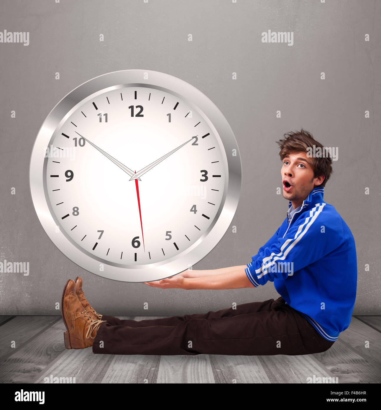 Attractive boy holding a huge clock Stock Photo - Alamy