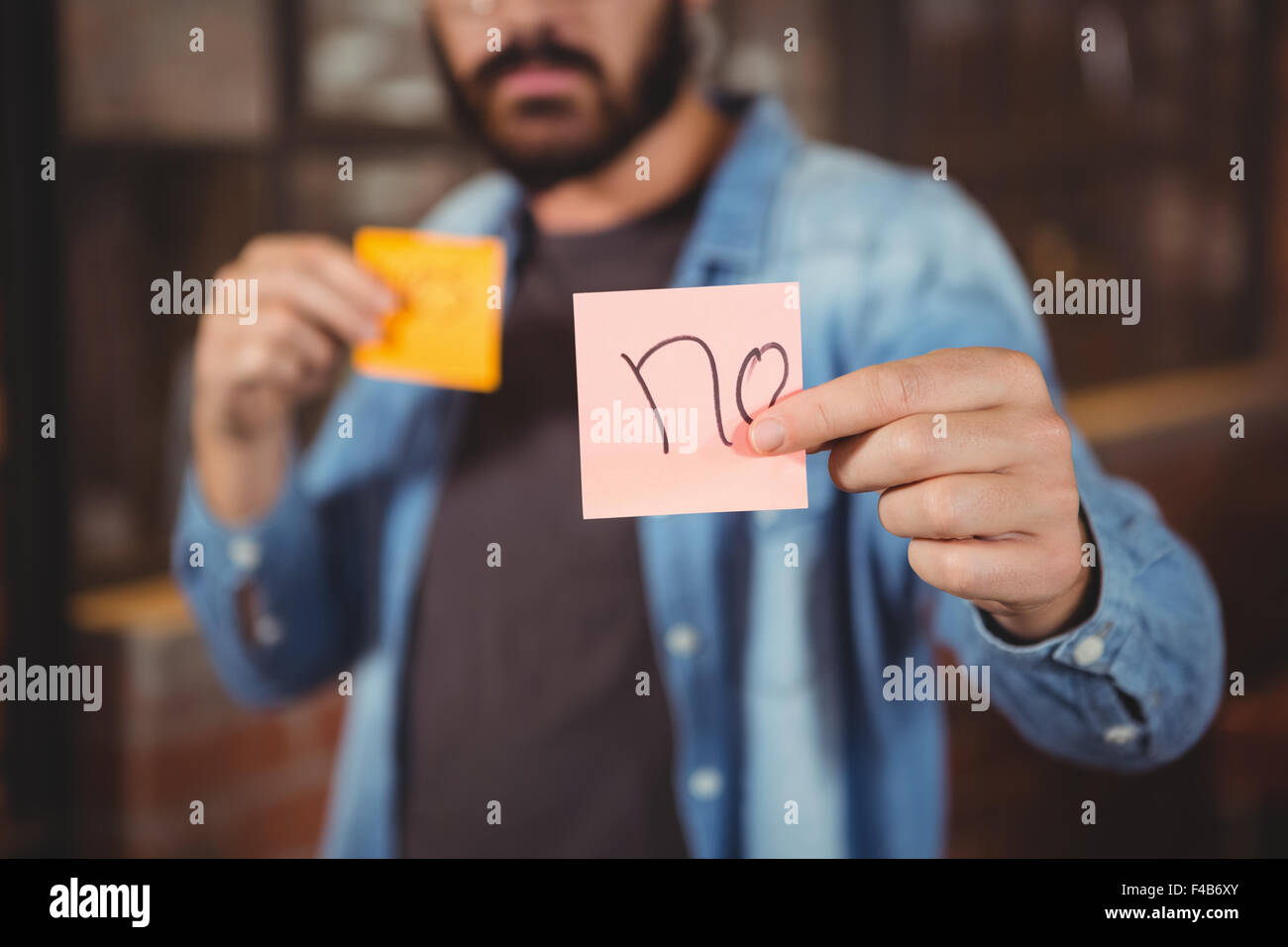 Close-up of man showing adhesive note Stock Photo - Alamy