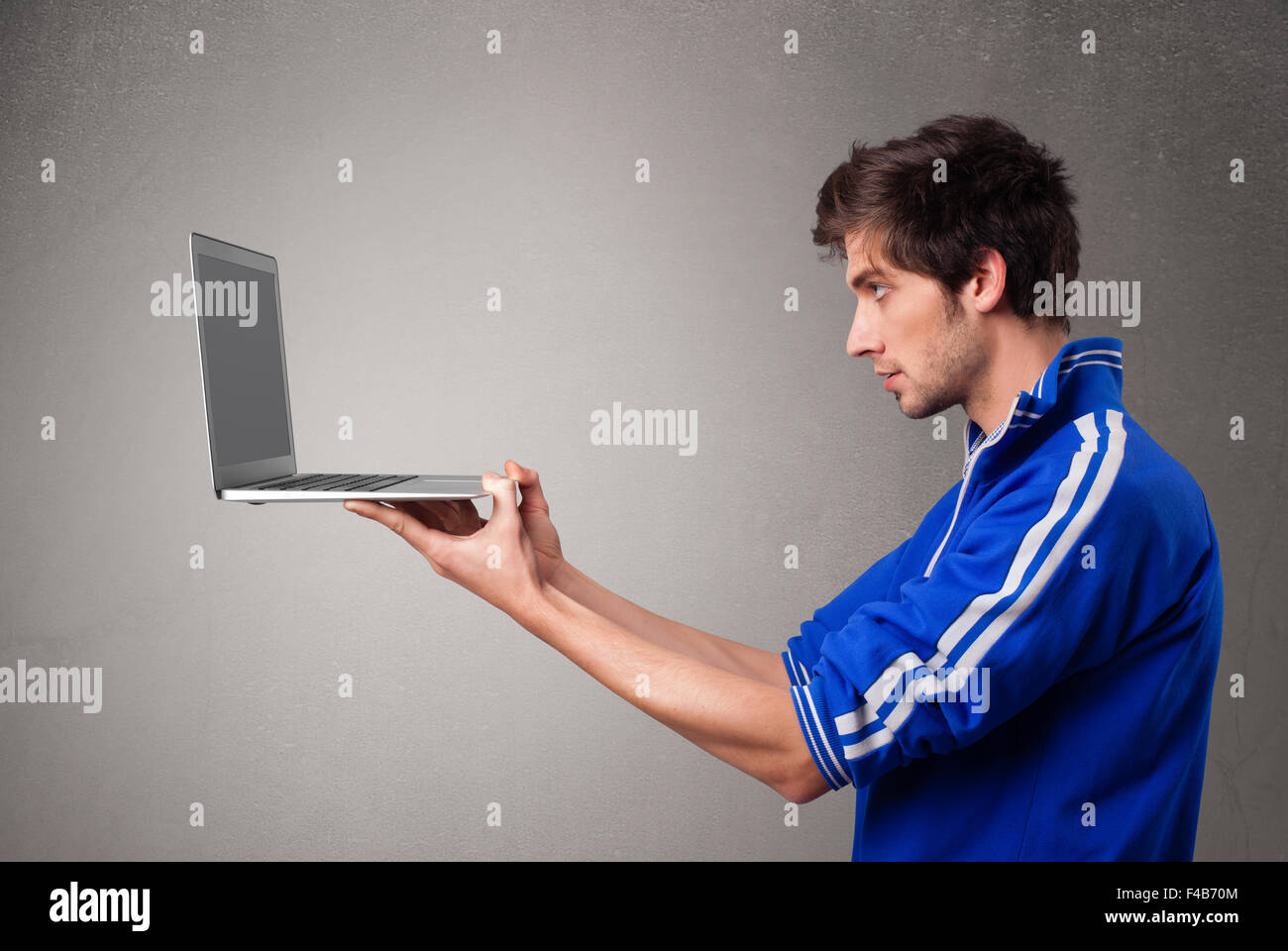 Attractive man holding modern notebook Stock Photo - Alamy
