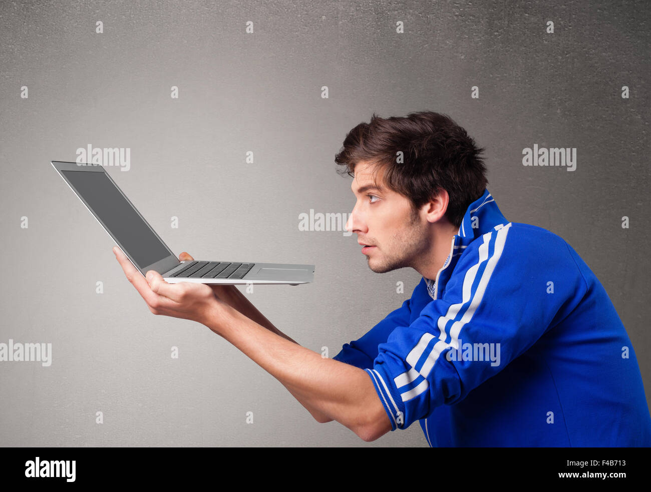 Attractive man holding modern notebook Stock Photo - Alamy