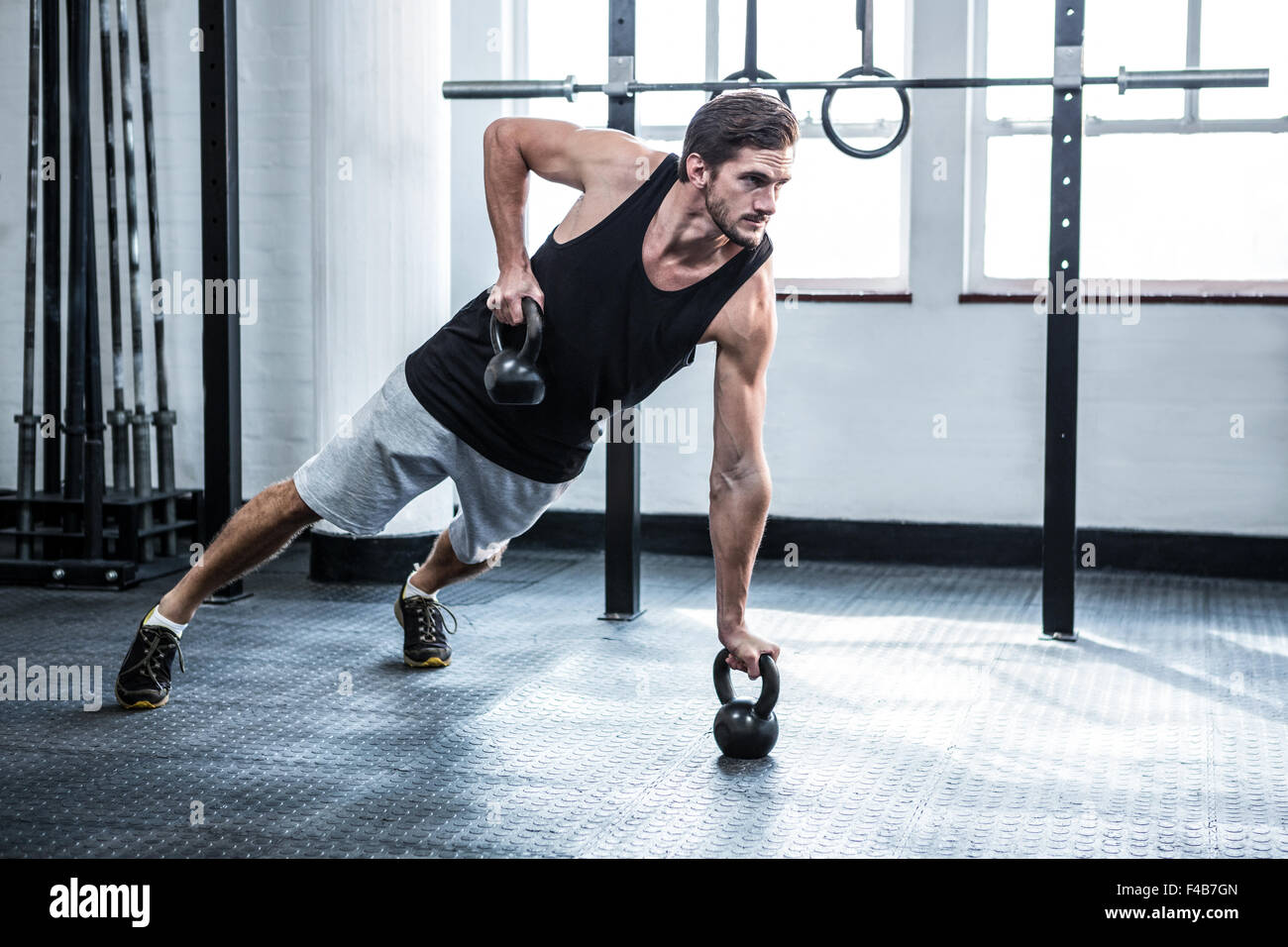 Fit man working out with kettlebells Stock Photo - Alamy