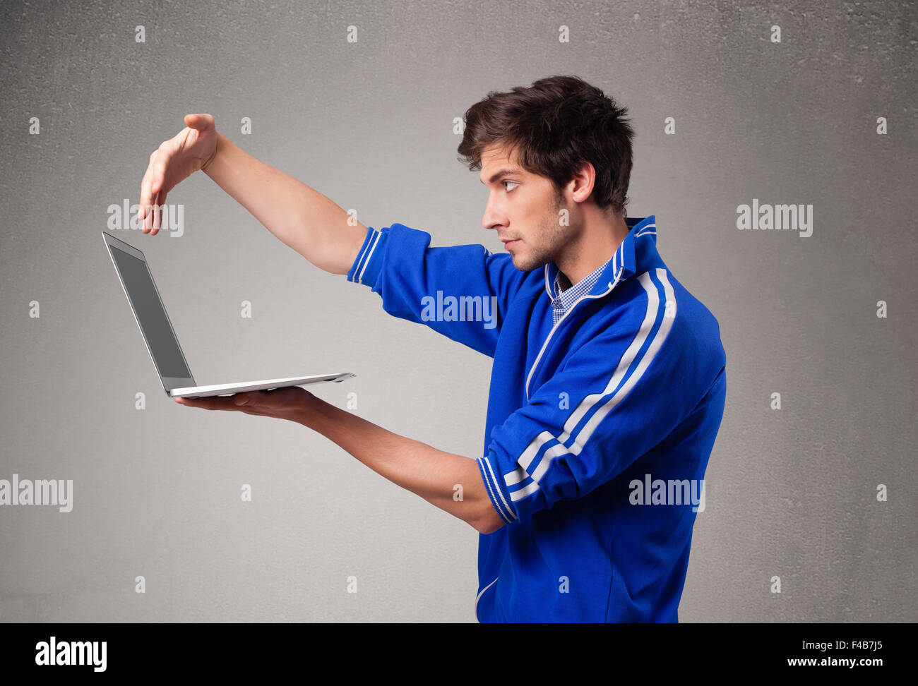Attractive man holding modern notebook Stock Photo - Alamy