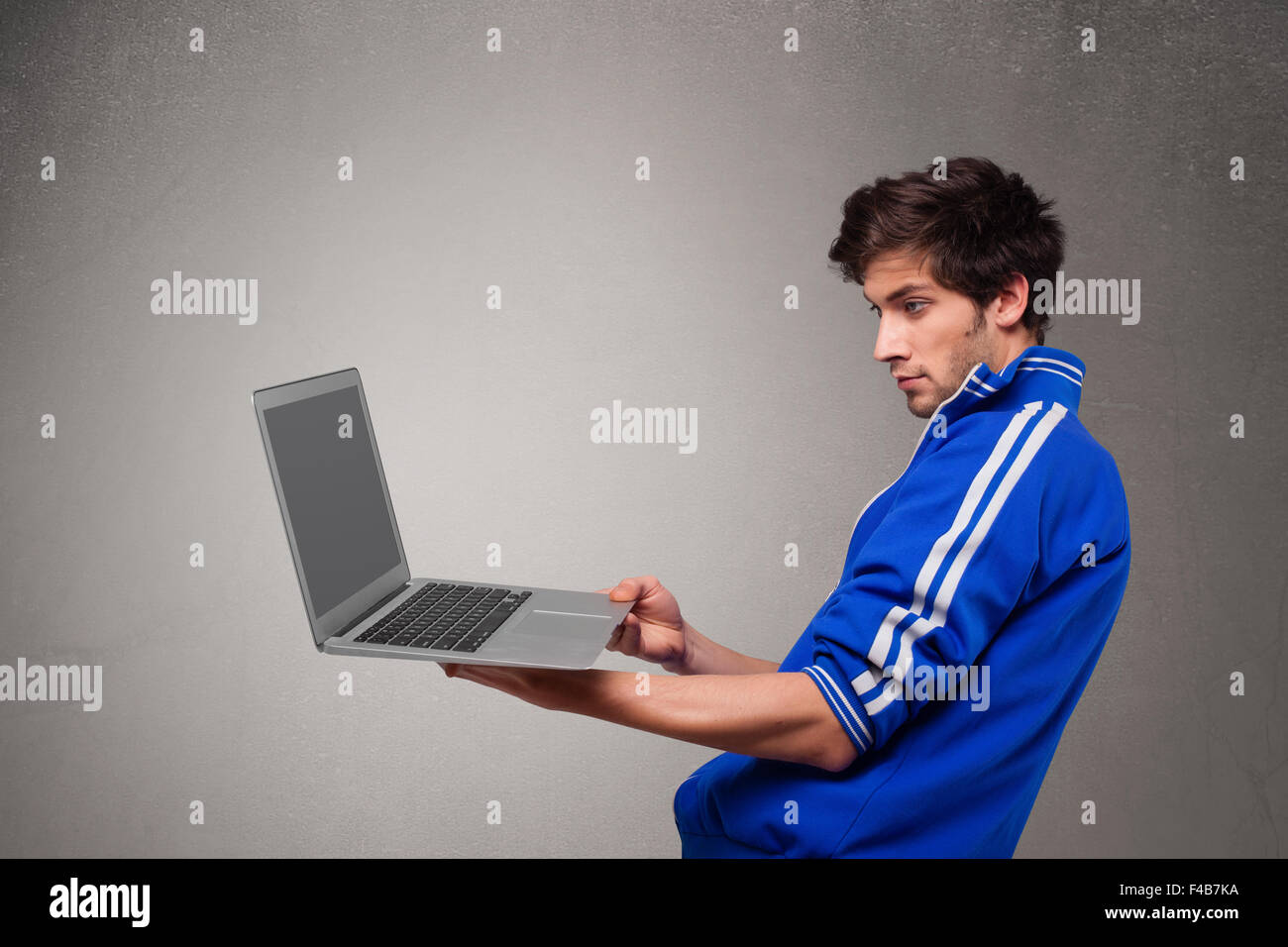 Attractive man holding modern notebook Stock Photo - Alamy