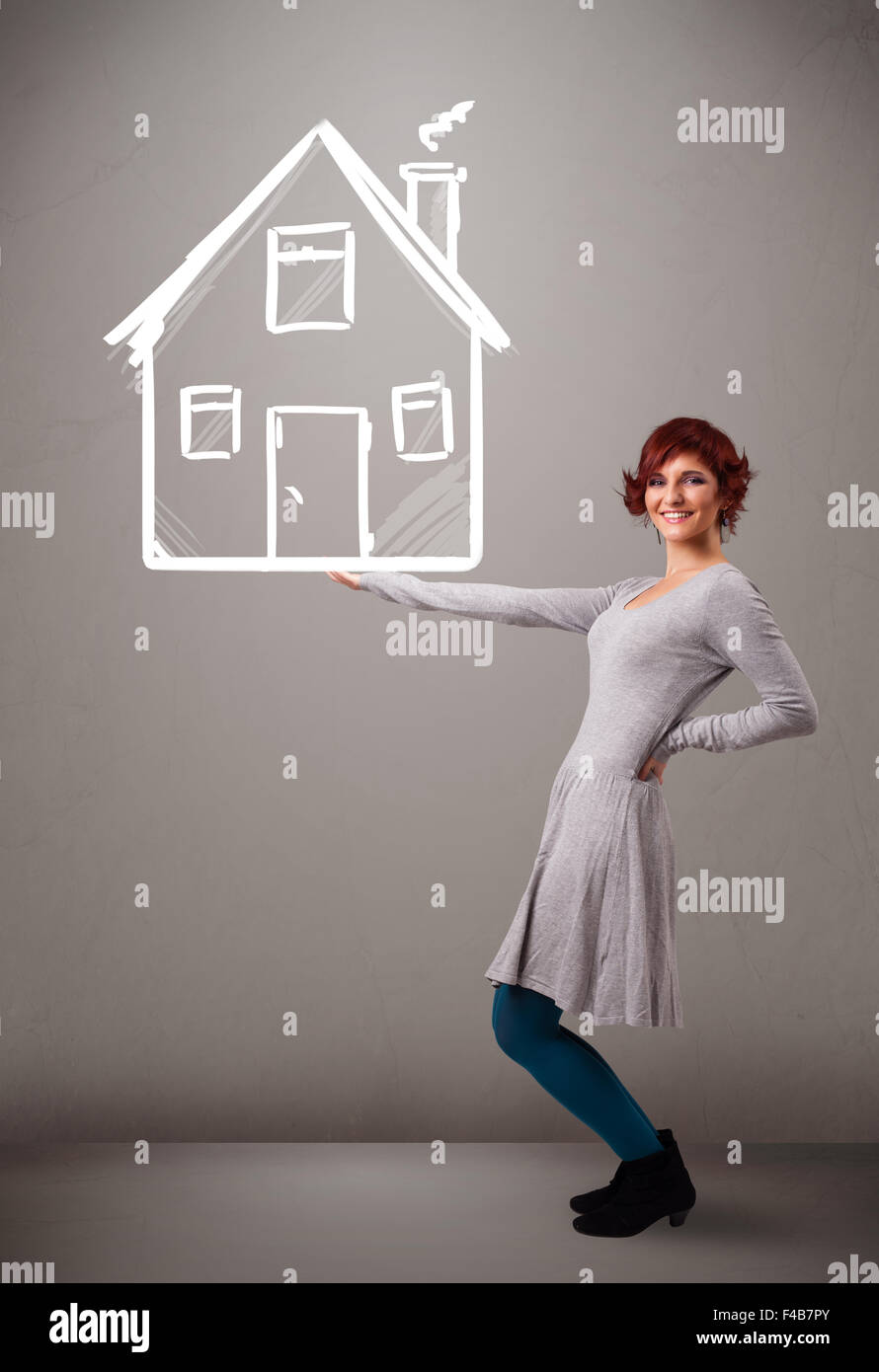 Young lady holding a huge drawn house Stock Photo - Alamy