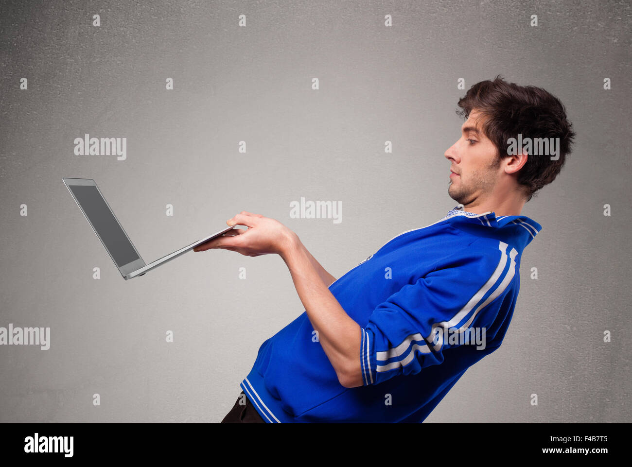 Attractive man holding modern notebook Stock Photo - Alamy