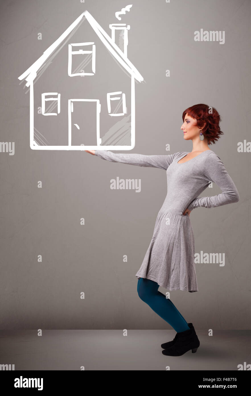Young lady holding a huge drawn house Stock Photo - Alamy