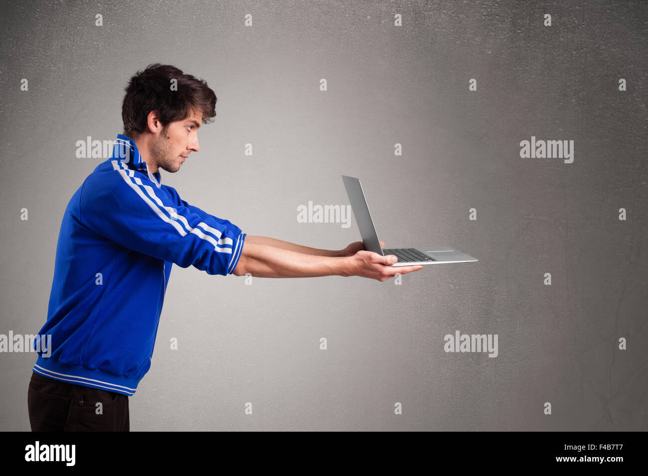 Attractive man holding modern notebook Stock Photo - Alamy