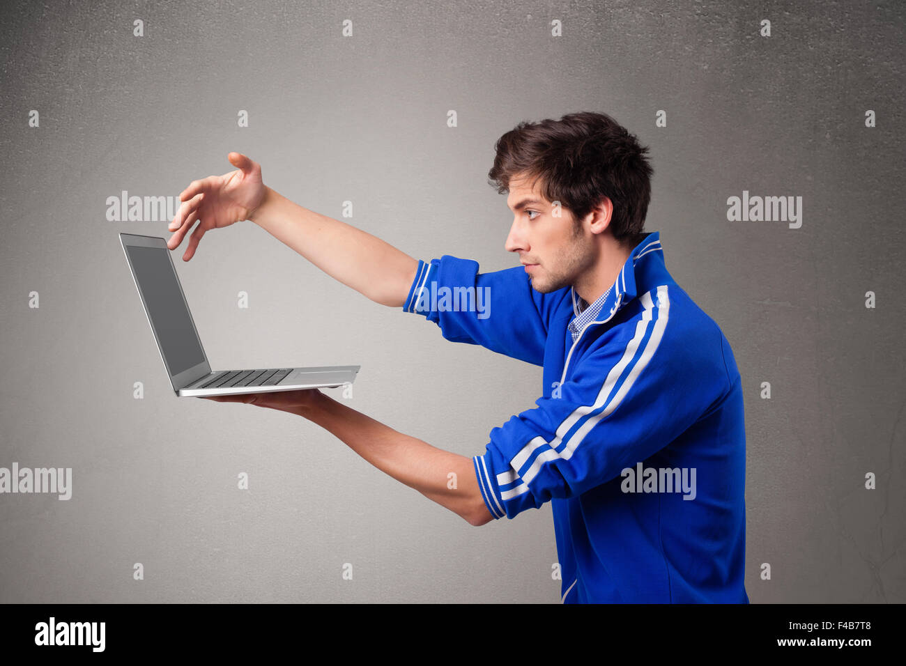 Attractive man holding modern notebook Stock Photo - Alamy