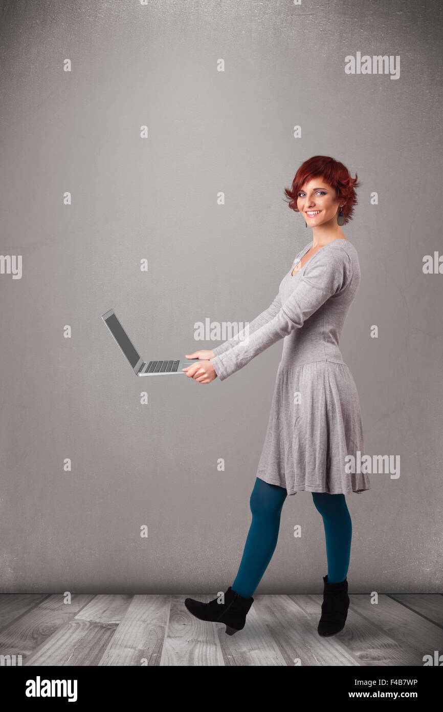 Young woman holding modern laptot Stock Photo - Alamy