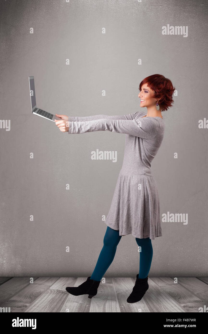Young woman holding modern laptot Stock Photo - Alamy