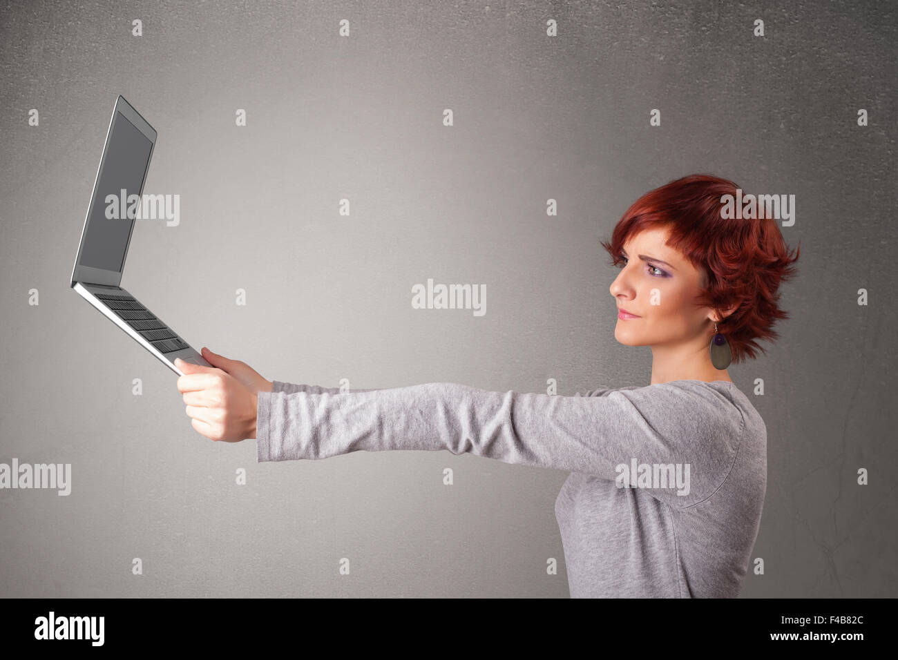 Young woman holding modern laptot Stock Photo - Alamy