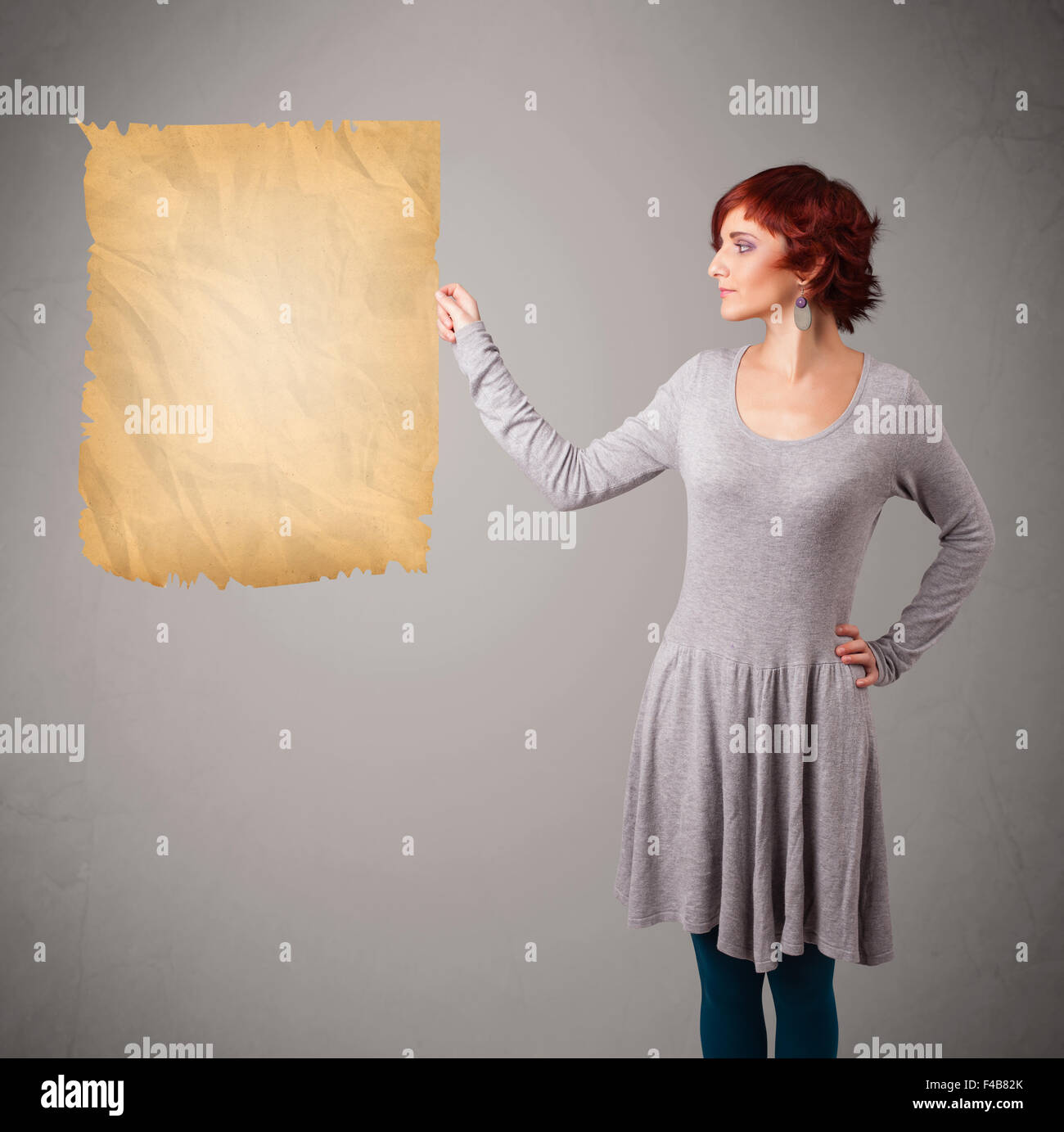 Young girl presenting old paper copy space Stock Photo - Alamy