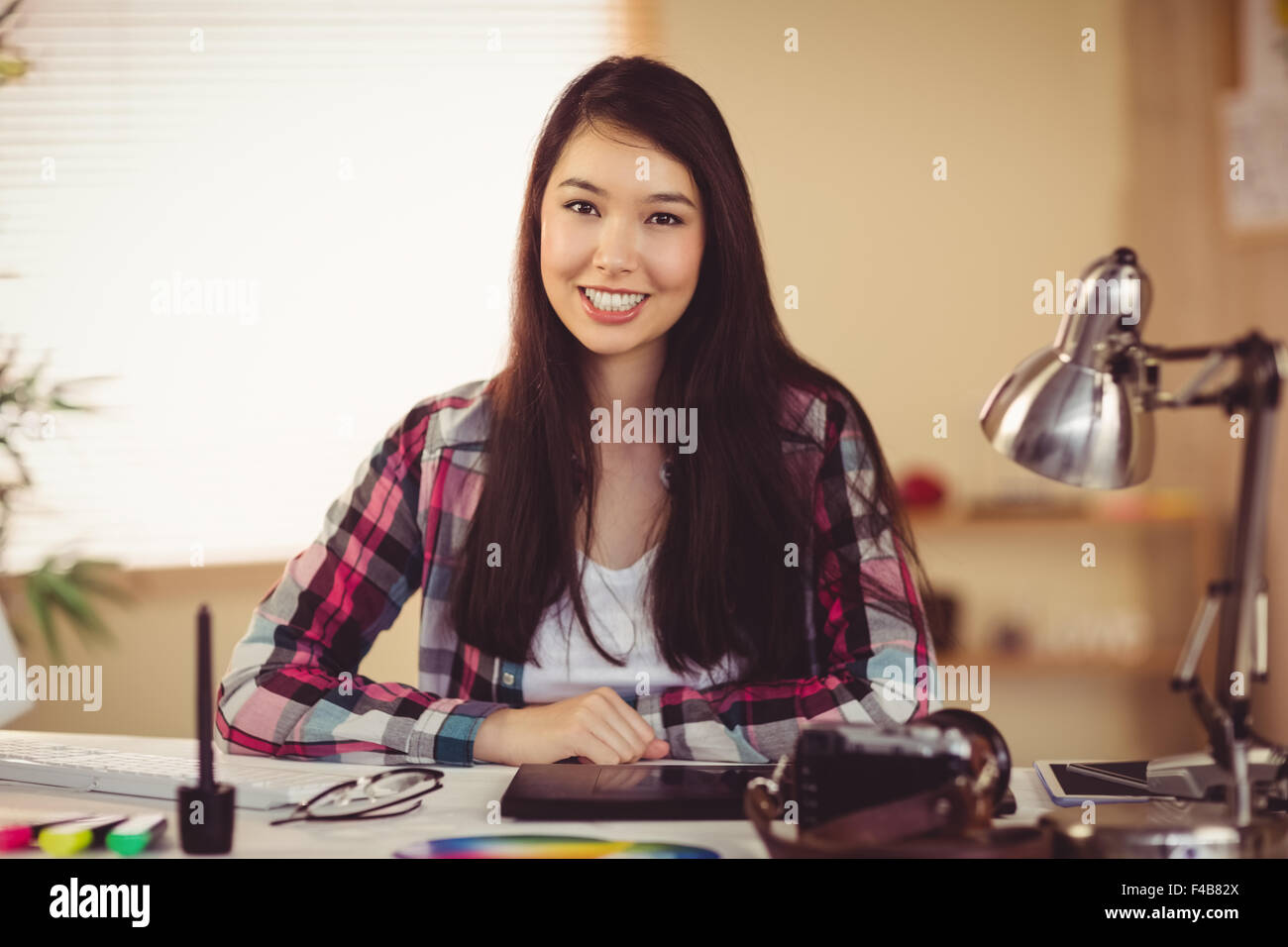 Young creative woman smiling at the camera Stock Photo - Alamy