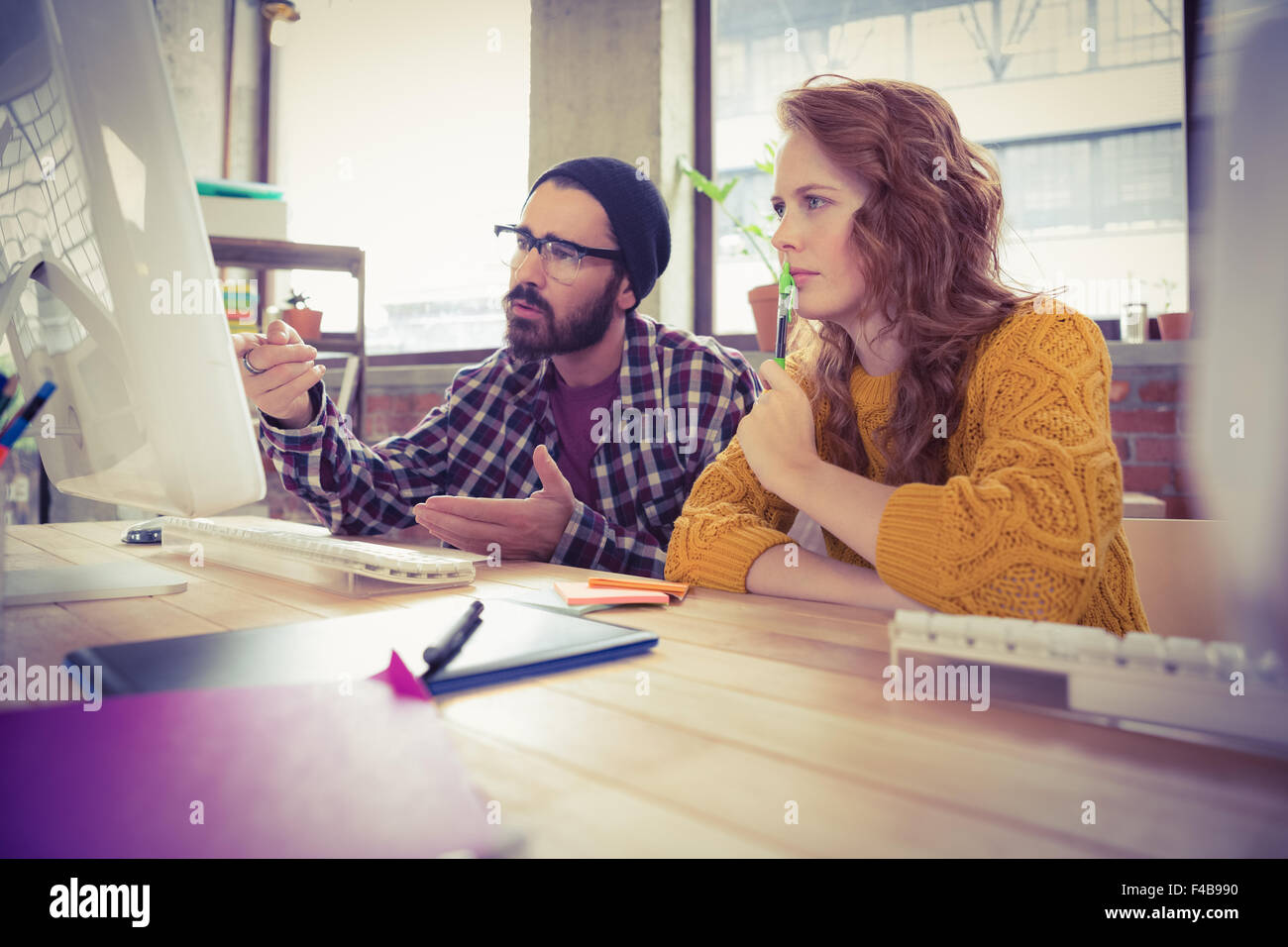 Serious colleagues discussing at office Stock Photo - Alamy