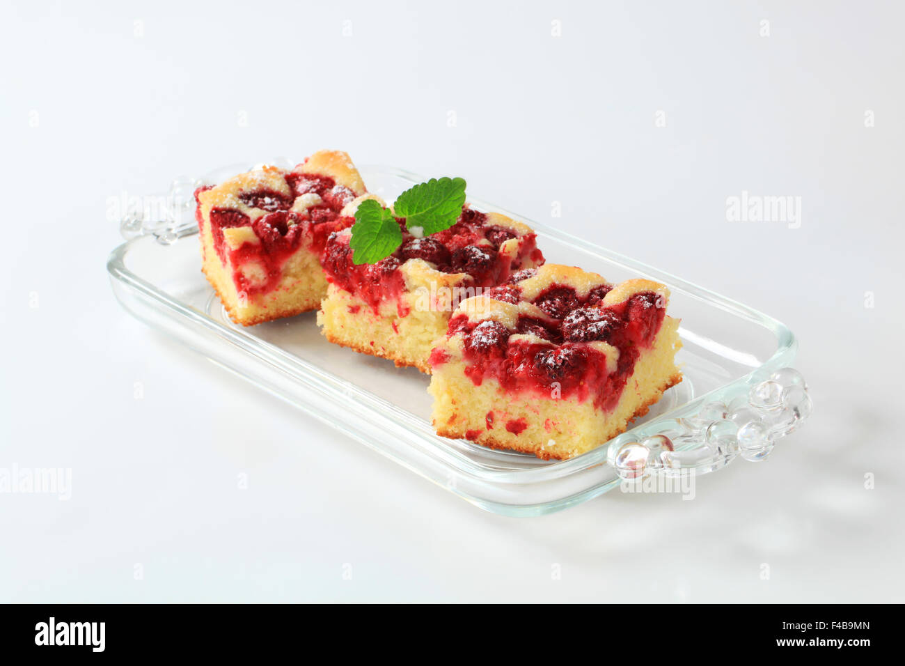 raspberry sponge cake squares on glass tray Stock Photo - Alamy