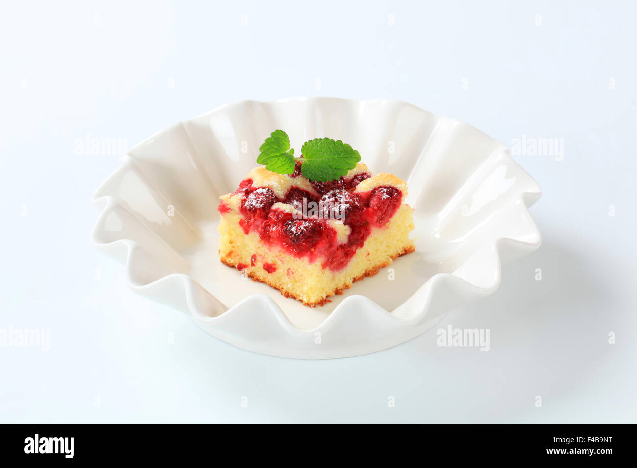 raspberry sponge cake slice in decorative dish Stock Photo - Alamy