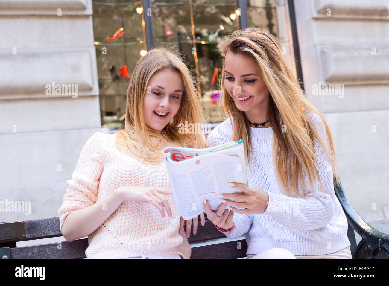 friends reading a magazine together Stock Photo - Alamy