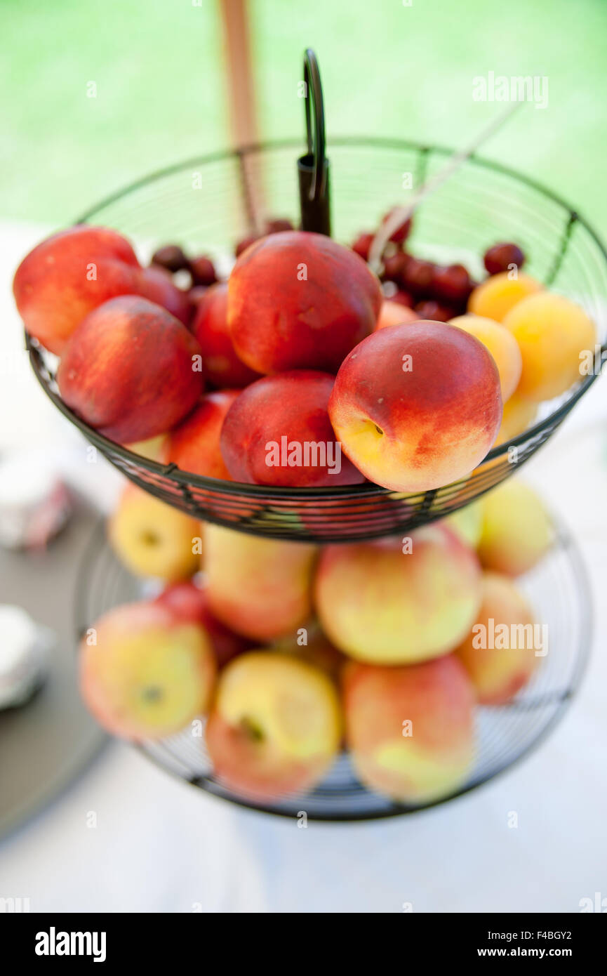 Basket full with Apples and Peaches Stock Photo - Alamy
