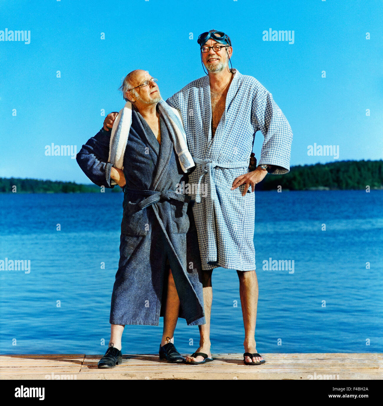 Men in robes standing at the beach Stock Photo - Alamy