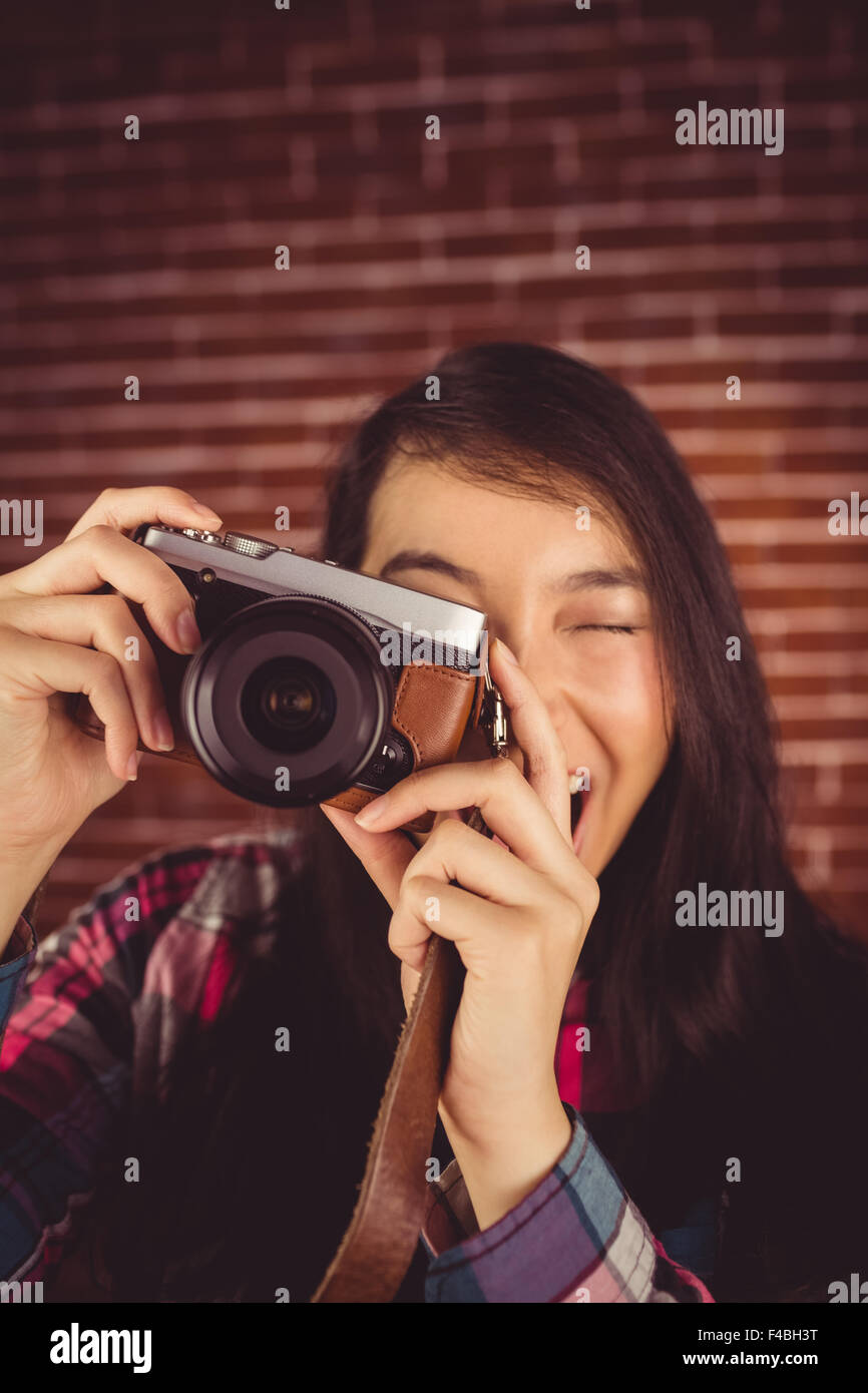 Attractive hipster photographing with camera Stock Photo - Alamy