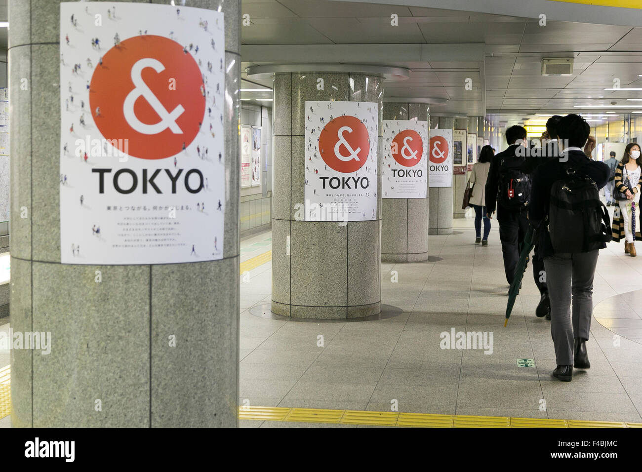 Tokyo, Japan. 16th Oct, 2015. Commuters walk past a ''& TOKYO'' poster ...
