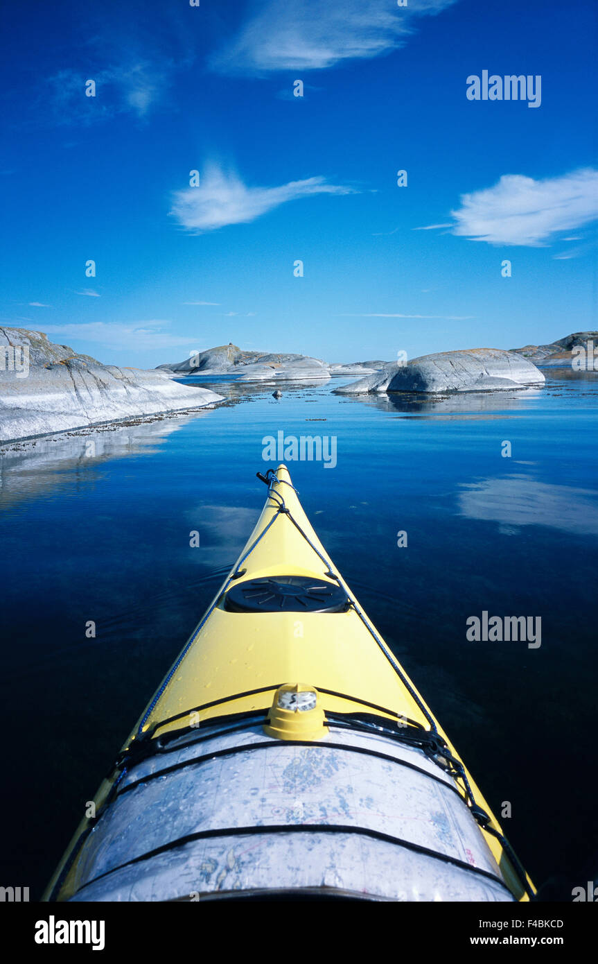 Kayak lying in the water with cliffs on either side and blue sky Stock ...