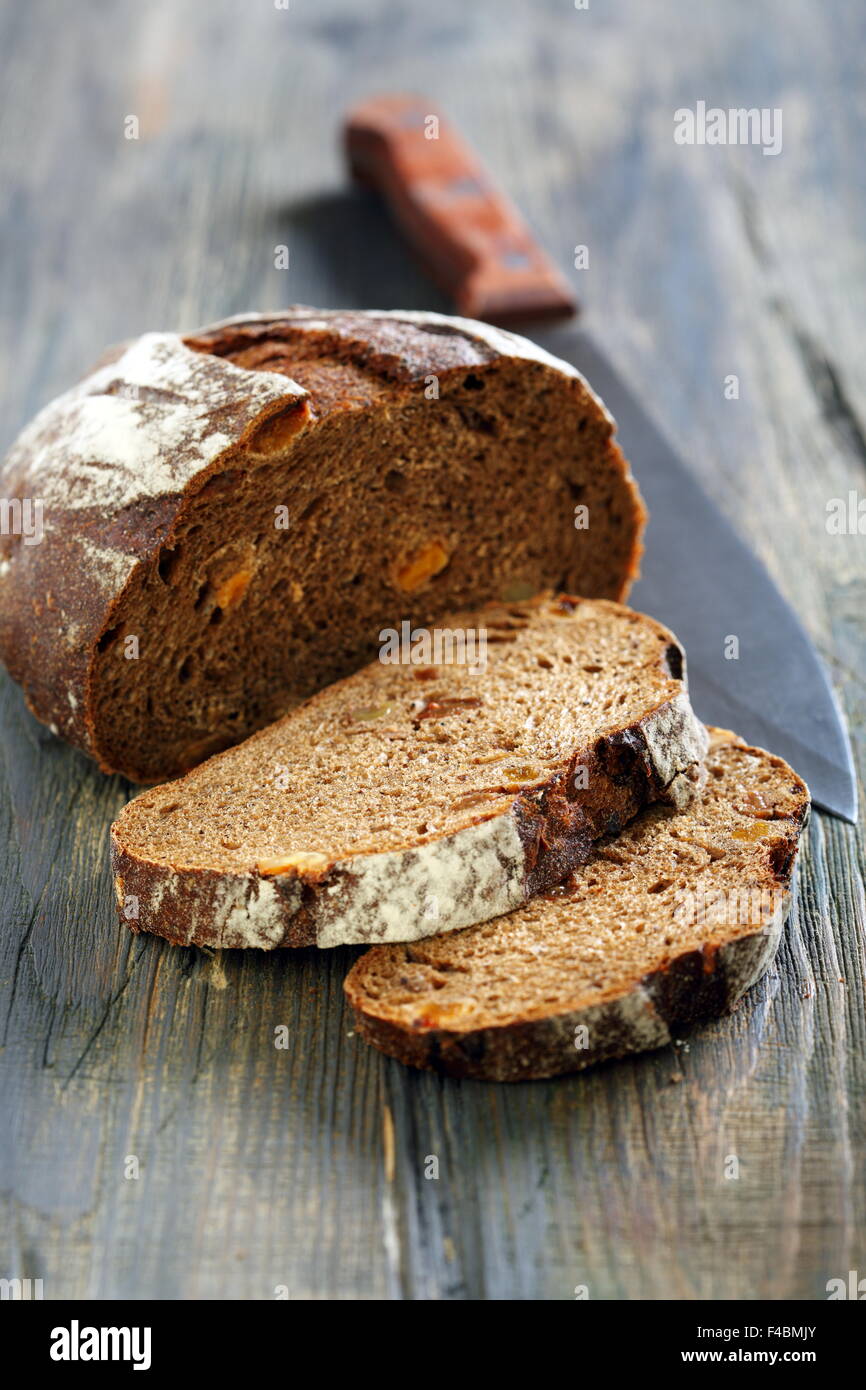 Rye bread with dried apricots and a knife Stock Photo - Alamy