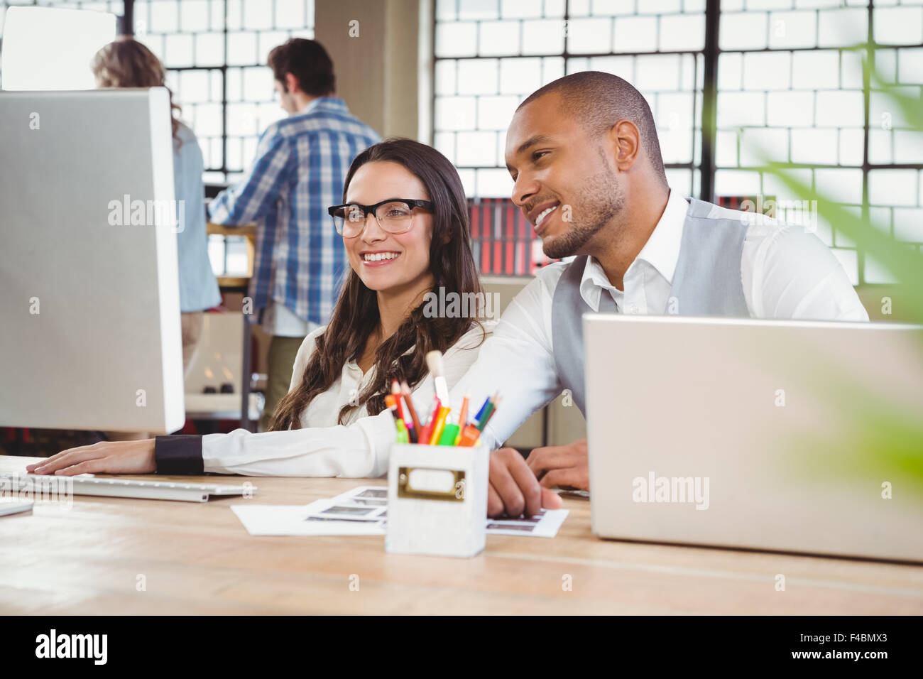 People looking at computer Stock Photo - Alamy