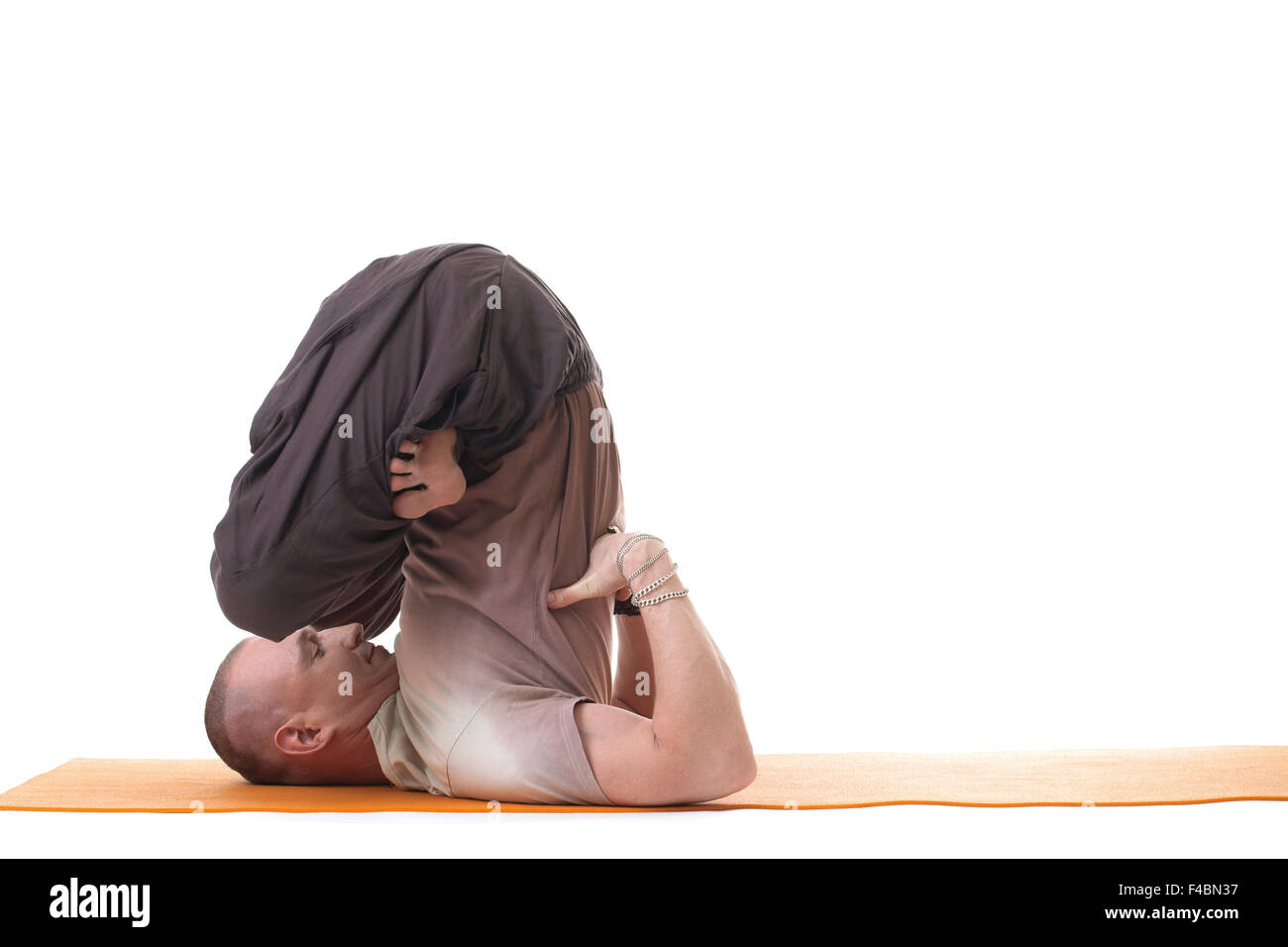 Yoga trainer posing in difficult asana Stock Photo - Alamy