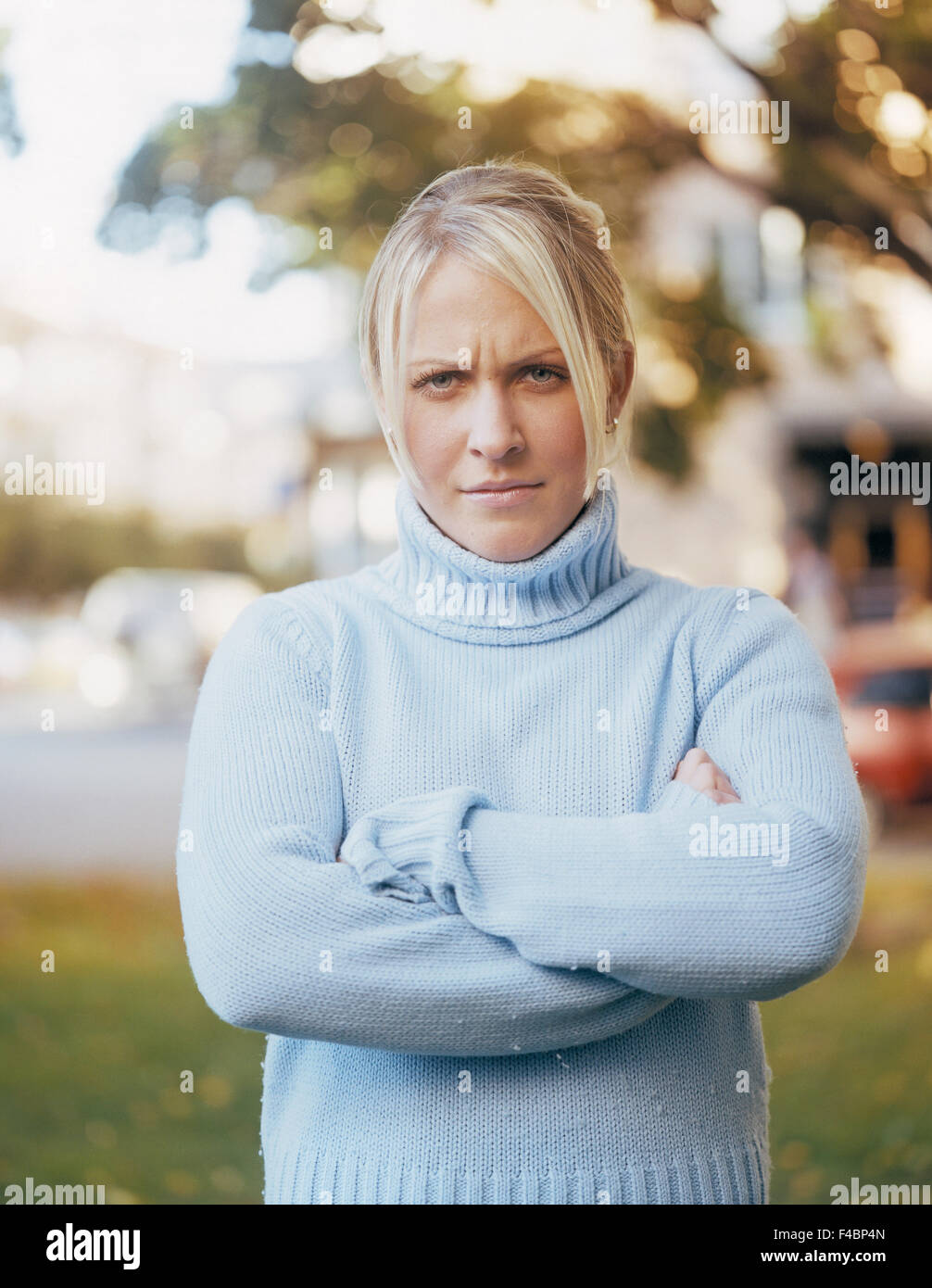 Closeup of angry woman in a blue sweater Stock Photo - Alamy