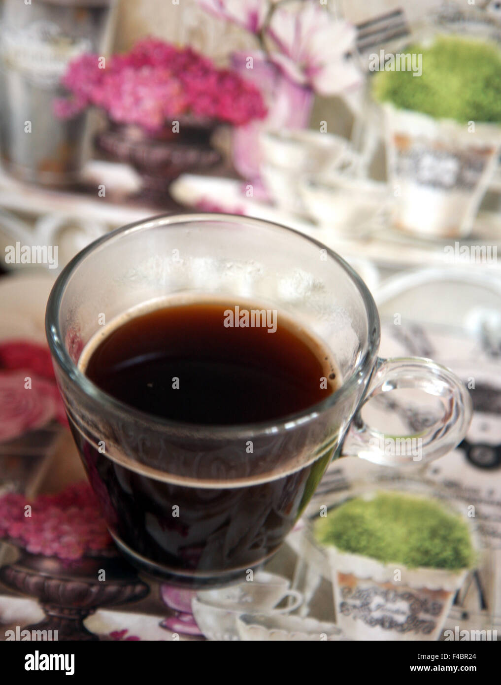 Cup of coffee over floral background Stock Photo - Alamy