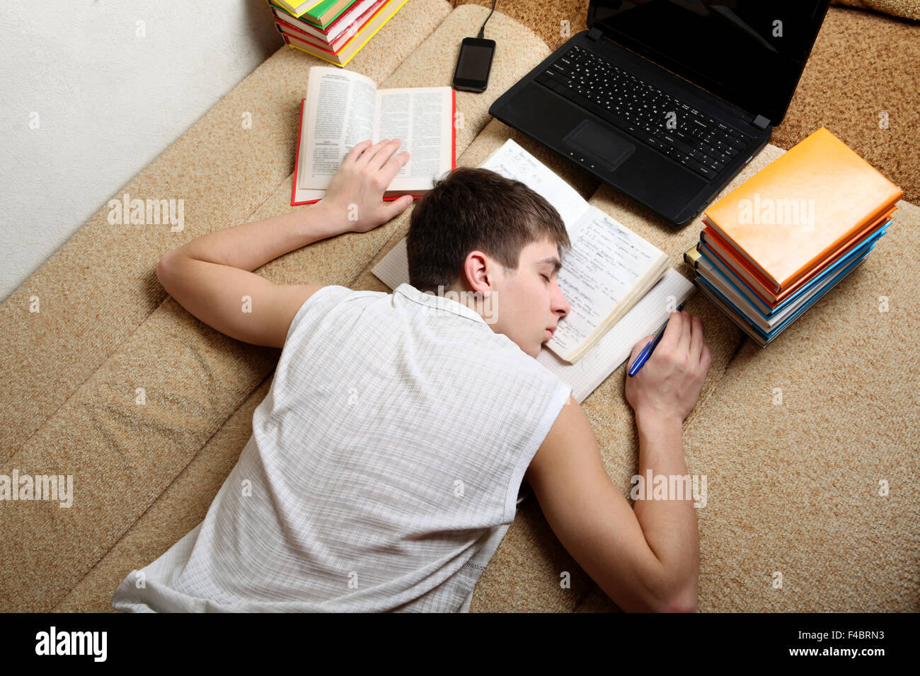 Teenager sleeps after Learning Stock Photo - Alamy