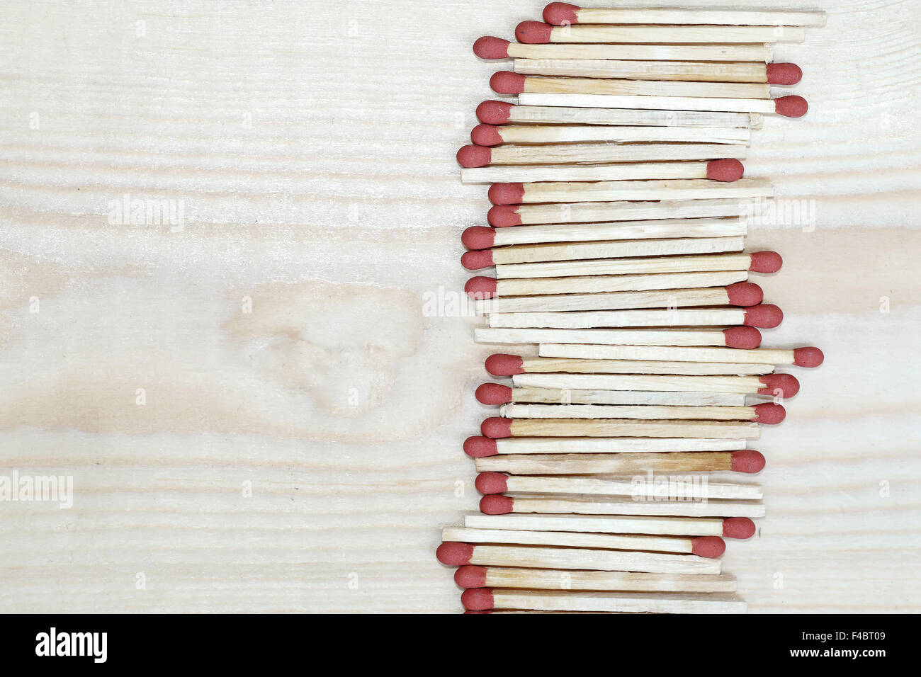 matchstick line on wooden background Stock Photo - Alamy