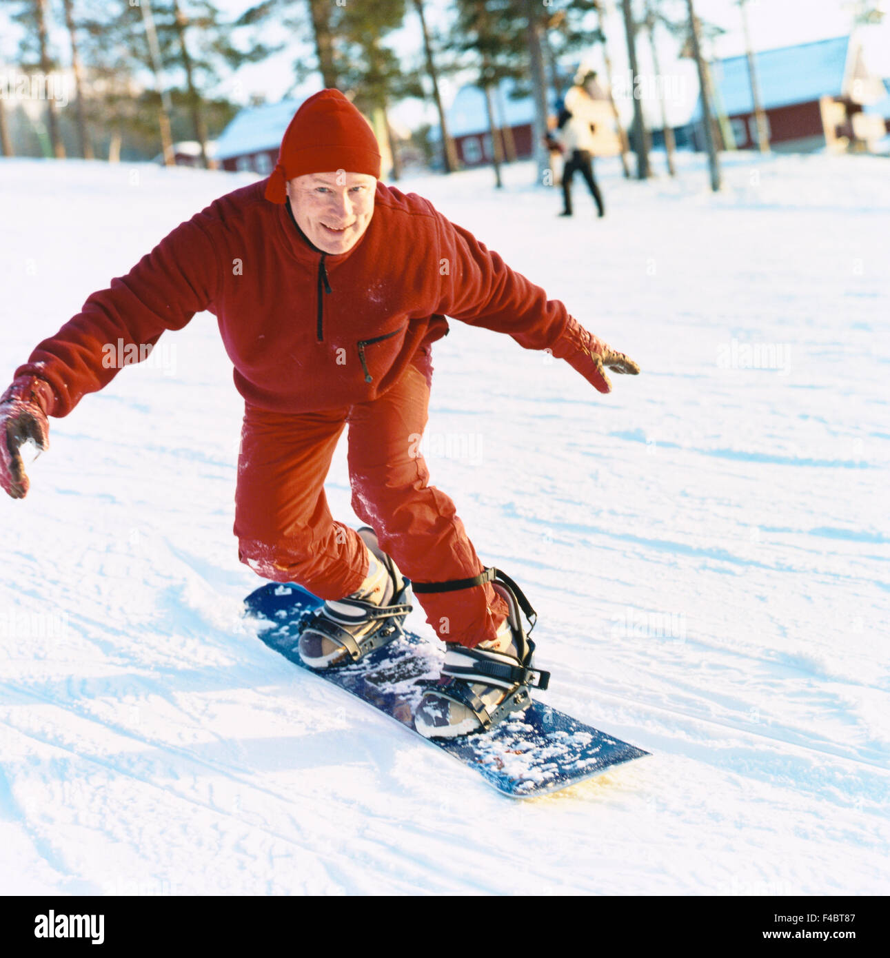 Man snowboarding downhill Stock Photo - Alamy